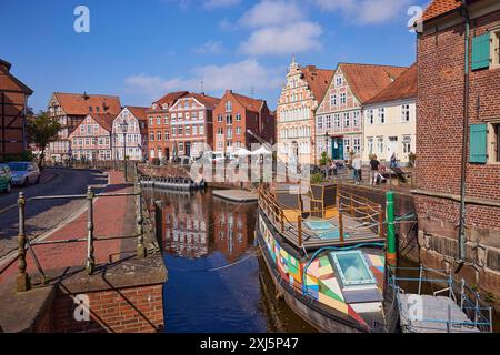 Harbour basin with railings, boats and the gabled houses, brick ...