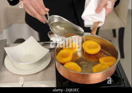 Preparing peaches flambé Stock Photo - Alamy