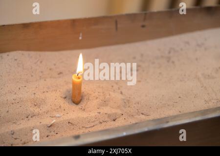 Small candlelight that have yellow spots on purple light and white ...