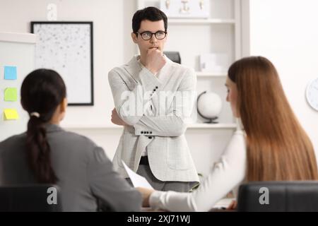 Man feeling embarrassed during business meeting in office Stock Photo ...