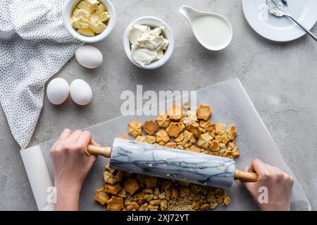 Woman crushing tart ingredient with rolling Pin while working in ...