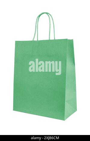 Recycled kraft paper bag with green leaves on green background ...