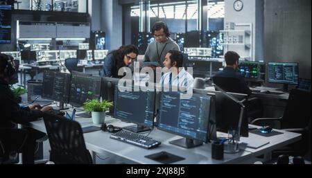 Group of Three Young Indian Software Engineers Use Computer to Discuss ...
