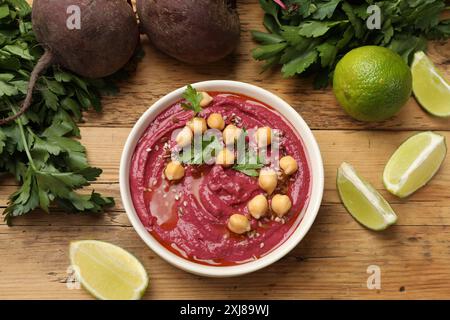 Bowl with tasty hummus and ingredients on dark background Stock Photo ...