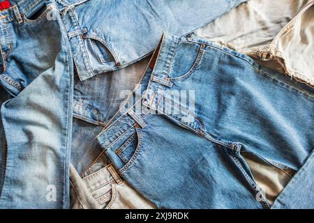 many denim blue jeans background. Top view Stock Photo - Alamy