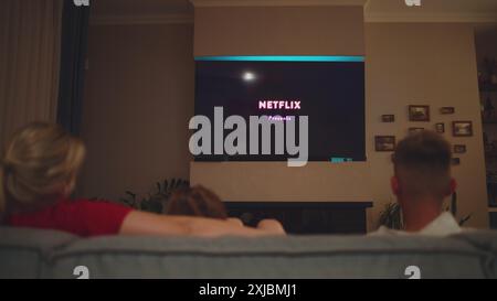 Cozy living room with the Netflix logo on a large smart TV Stock Photo ...