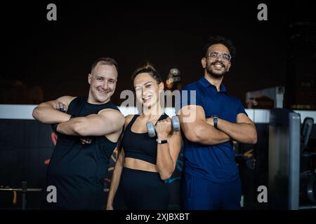 A group of men and one woman stand outdoors, some holding microphones ...