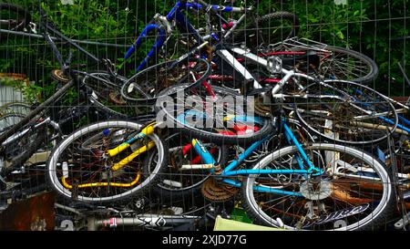 piles of cycles/bikes ready for recycling, including tyres, wheels and ...