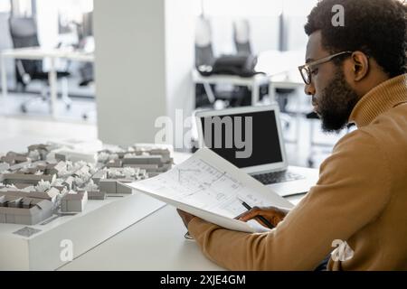 Professional man architect creating exterior designs in the workplace ...