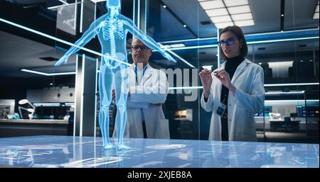 Two Bioengineers Working With Computer-Powered VFX Hologram Of Human ...
