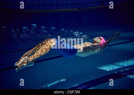 Swimmer's intense dive, highlighting his athletic physique and training ...