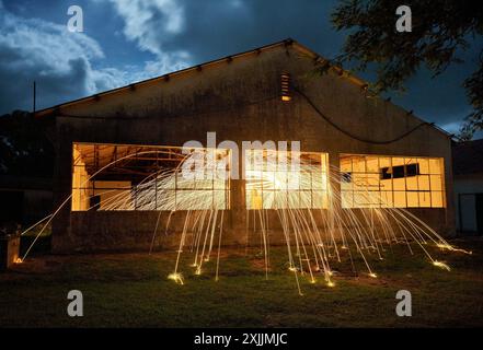 Long exposure photograph of neon pink colour in an abstract swirl ...