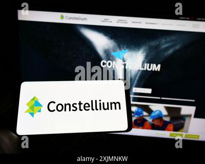 Person holding cellphone with website of French network solutions company InterCloud SAS on ...