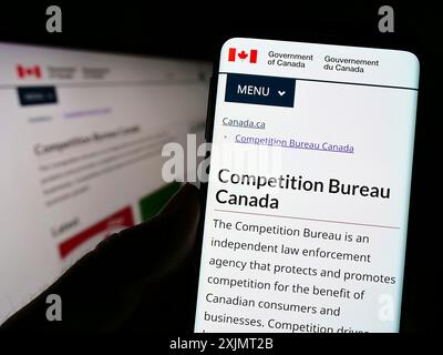 The Canadian Competition Bureau website on a mobile phone and laptop ...
