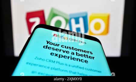 Mobile phone with webpage of Indian software company Zoho Corporation ...