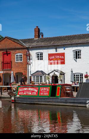 Canal narrowboat moored outside the Swan inn public house on the Trent ...