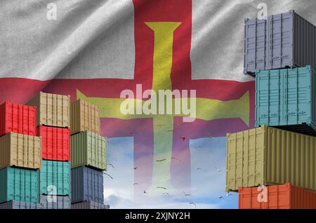 Guernsey flag and big stack of shipping cargo containers in docks with ...