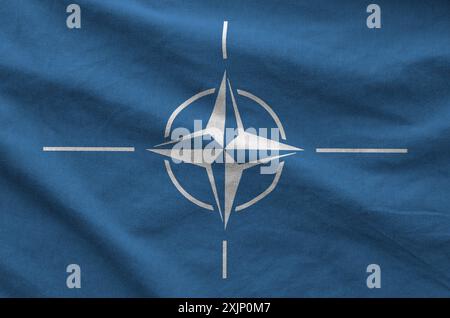 Nato flag depicted on folded wavy fabric of old cloth close up Stock ...