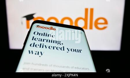 Smartphone with website of learning platform Moodle on screen in front ...