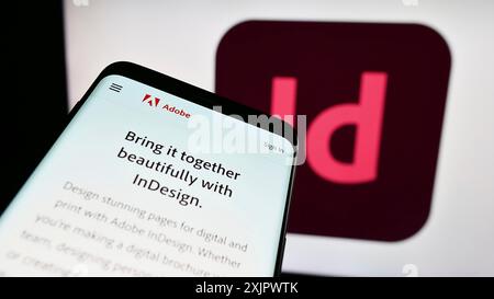 Mobile phone with webpage of desktop publishing software Adobe InDesign ...