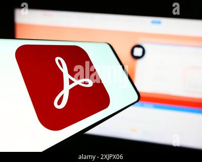 Cellphone with logo of PDF management software Adobe Acrobat on screen ...