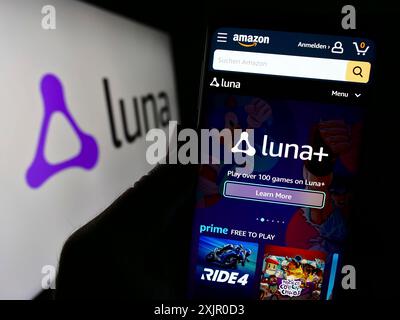 Person holding smartphone with website of platform Downdetector and ...