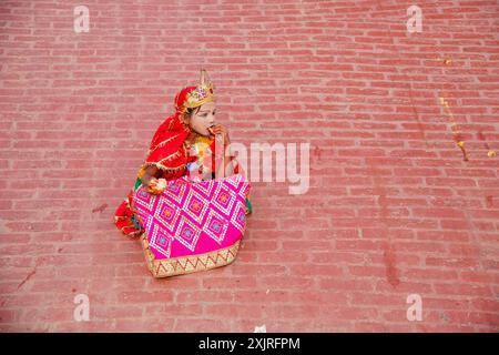 Portrait of a poor kid dressed as Lord Shiva and Goddess Parvati with a ...