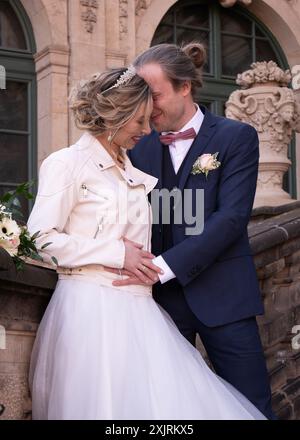 The bride and groom tenderly hug a friend, wedding day, tenderness ...