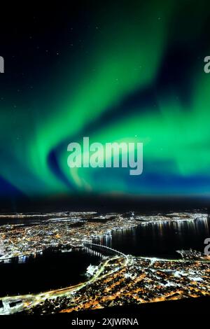 The Northern Lights over Tromso city, Troms county, Norway Stock Photo ...