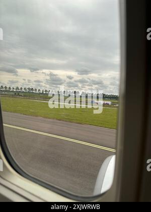 View on runway and surroundings through plane window Stock Photo - Alamy