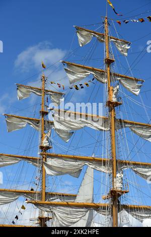 A detailed view of ropes and blue pulleys on a traditional wooden ...