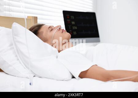 Coma patient. Young man sleeping in hospital bed Stock Photo - Alamy