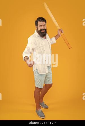angry man hold school ruler in studio with copy space banner. man hold ...