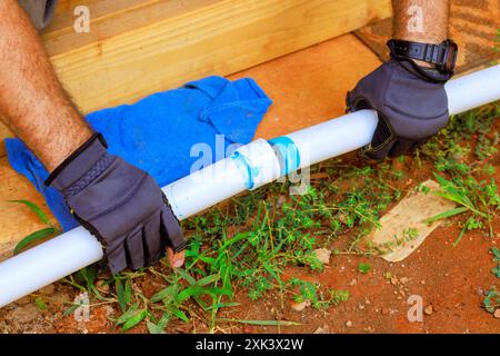 Contractor installing glues plastic PVC pipes for laying water ...