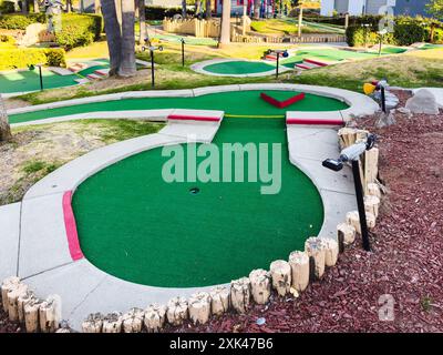 Colorful mini-golf course features various holes and playful challenges ...