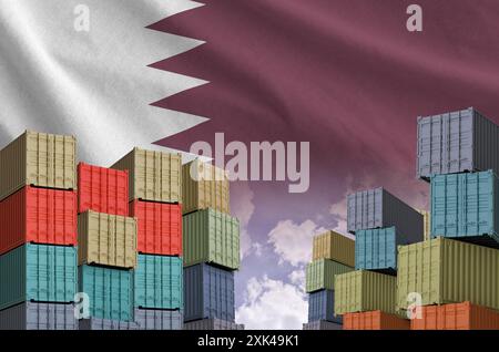 Qatar flag and big stack of shipping cargo containers in docks with sky ...