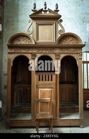 Confessional booth with ornate design in a church located in Auvergne ...