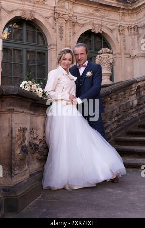 Beautiful happy married couple stands in the summer on retro bridge and ...