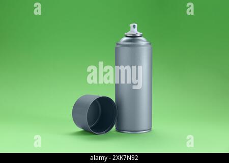 Spray paint can on green background Stock Photo - Alamy
