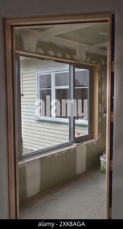 A 1950s weatherboard house with original windows and cladding, with a ...