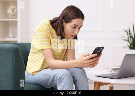 Woman with poor posture using smartphone at home Stock Photo - Alamy