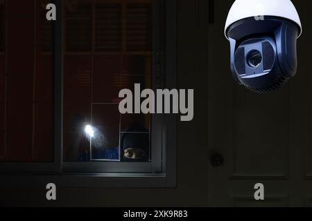 surveillance camera caught the robber in a mask with a knife Stock ...