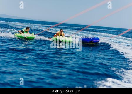 speedboat people tubing on the blue sea Stock Photo - Alamy