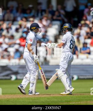Joe Root and Ollie Pope of England chat as they leave the field at the ...