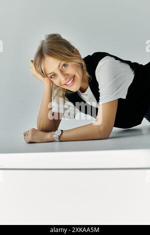 Blonde woman placing her hand on her forehead Stock Photo - Alamy