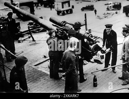 A British naval officer trains sailors on a gun of the type mounted on ...