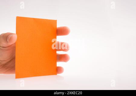 Hand holding orange color rectangular paper on a white background Stock ...