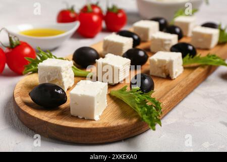 Board with feta cheese on grey background Stock Photo - Alamy