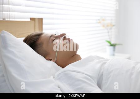 Coma patient. Young man sleeping in hospital bed Stock Photo - Alamy