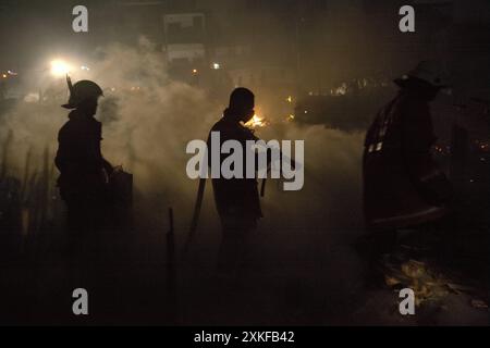Firefighters performing the cooling phase after a fire accident burned ...